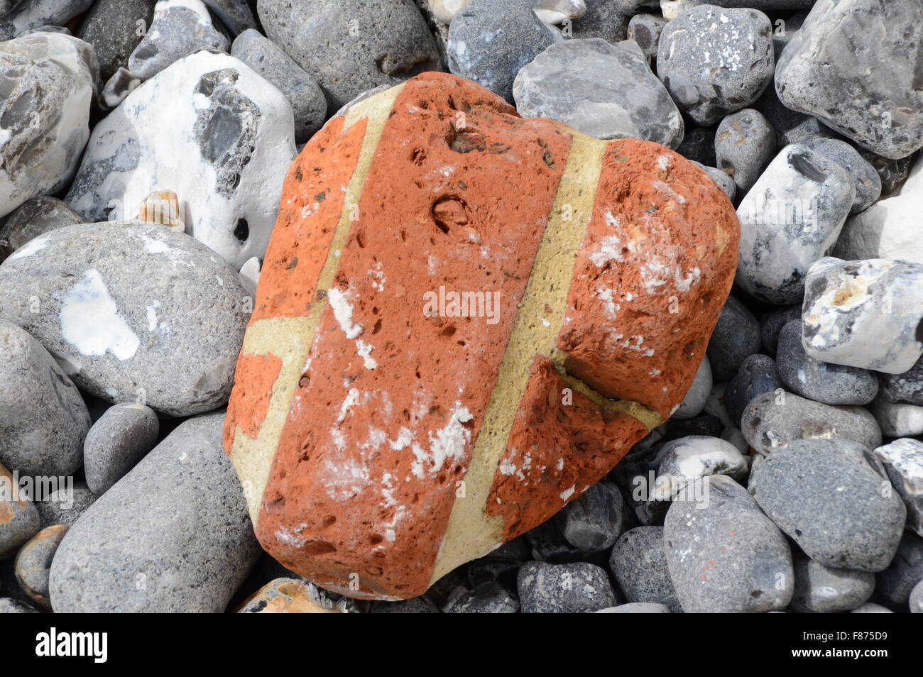 Eroded red brick on pebbles Stock Photo - Alamy