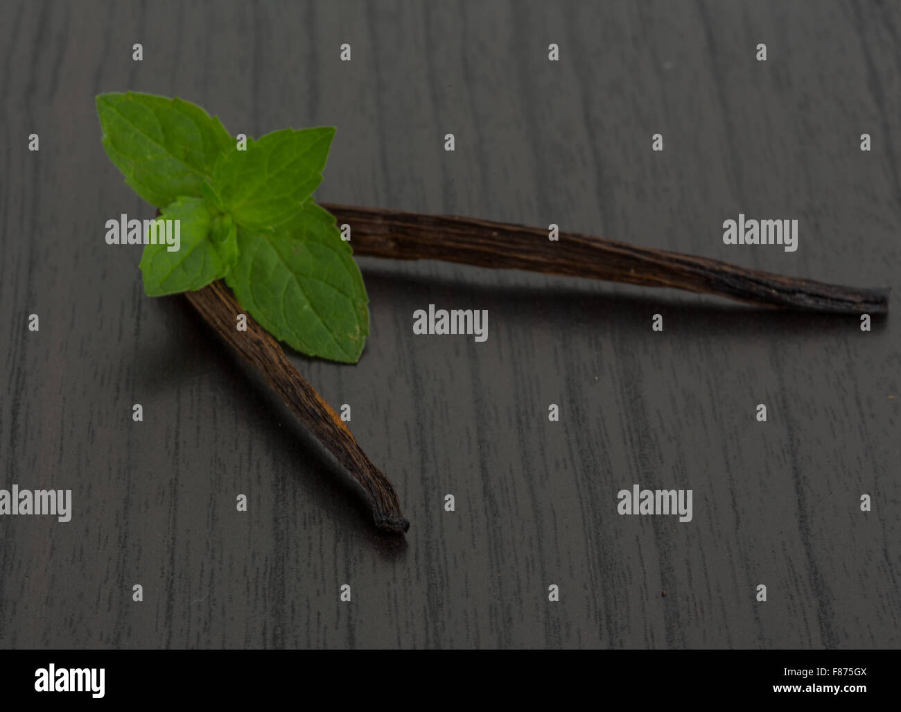 Vanilla with mint leaf on the board Stock Photo - Alamy