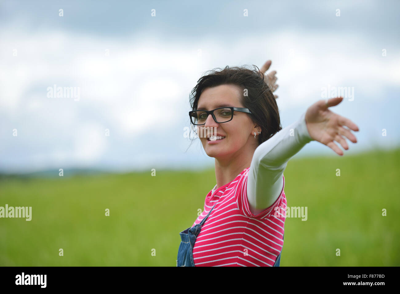 Enjoying the nature and life. Young woman arms raised enjoying the ...