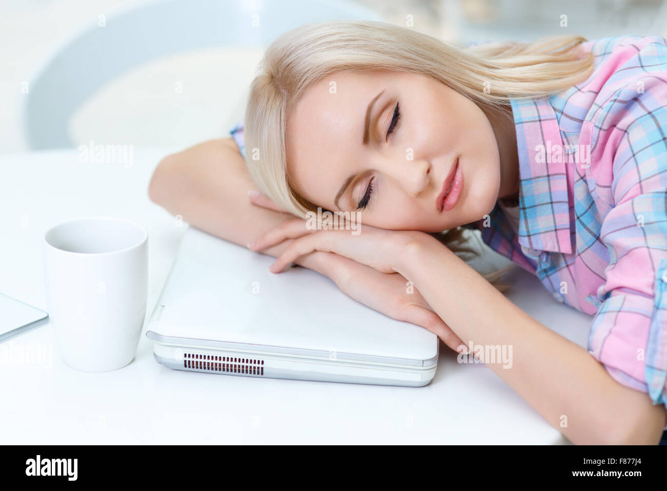 Pleasant woman sleeping on the table Stock Photo - Alamy