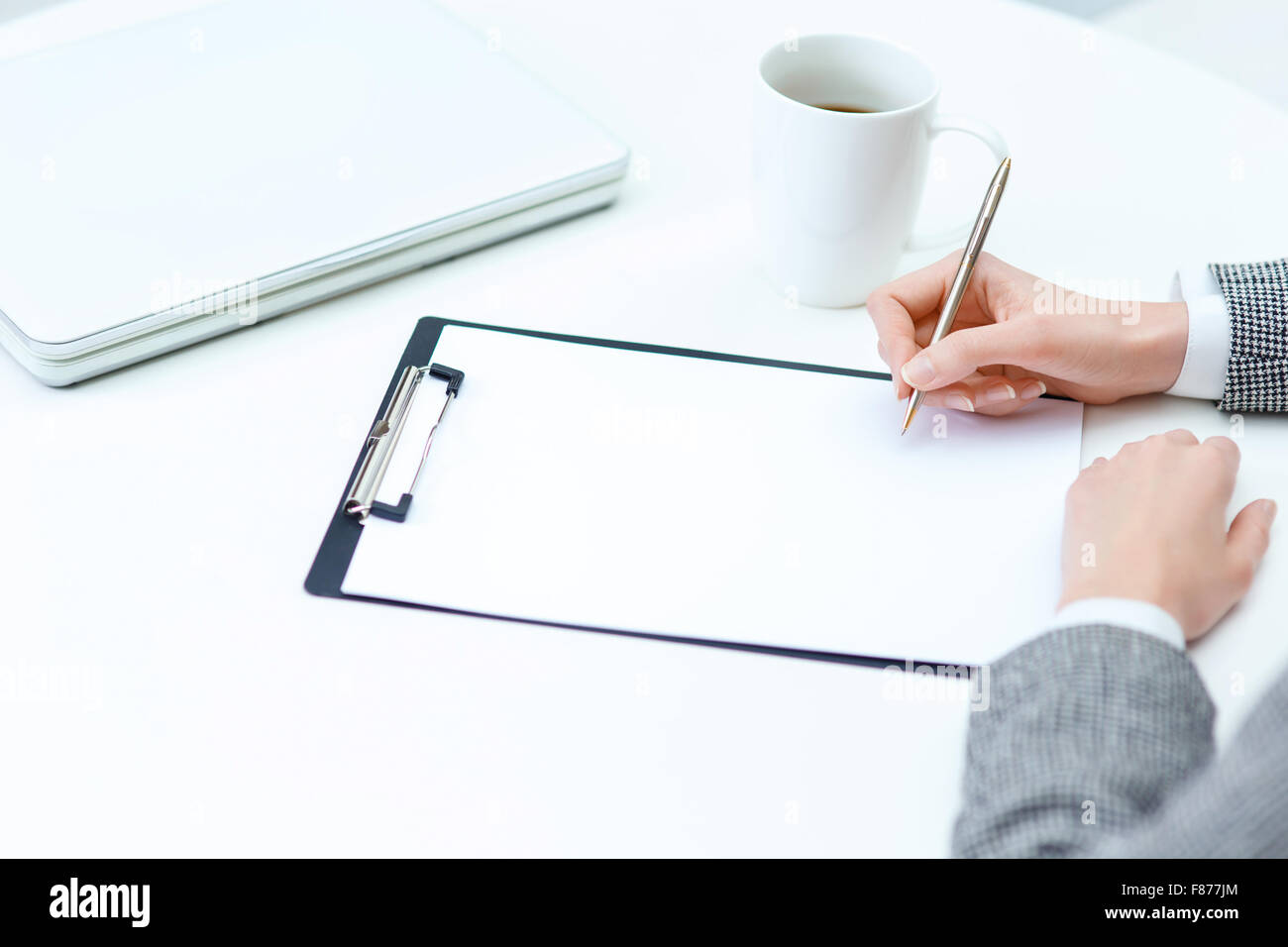 Pretty business woman signing papers Stock Photo - Alamy