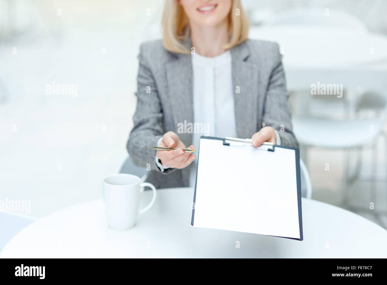 Pretty business woman signing papers Stock Photo - Alamy