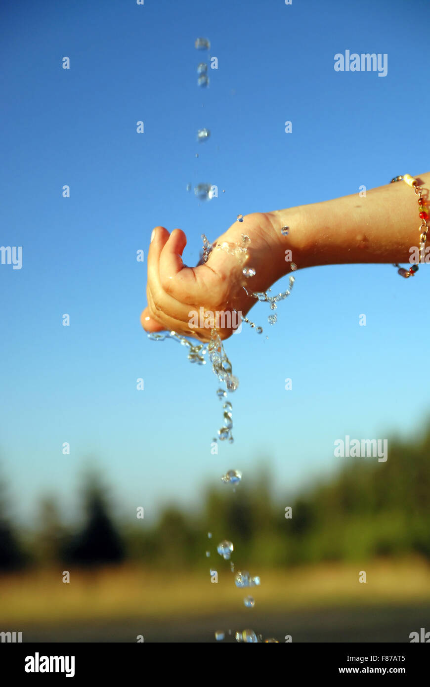clear water falling on children hands Stock Photo - Alamy