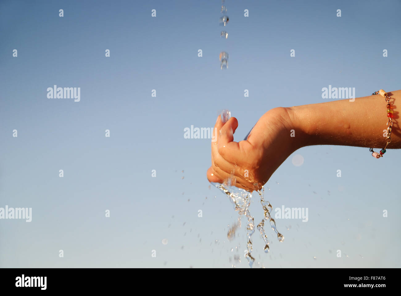 clear water falling on children hands Stock Photo - Alamy