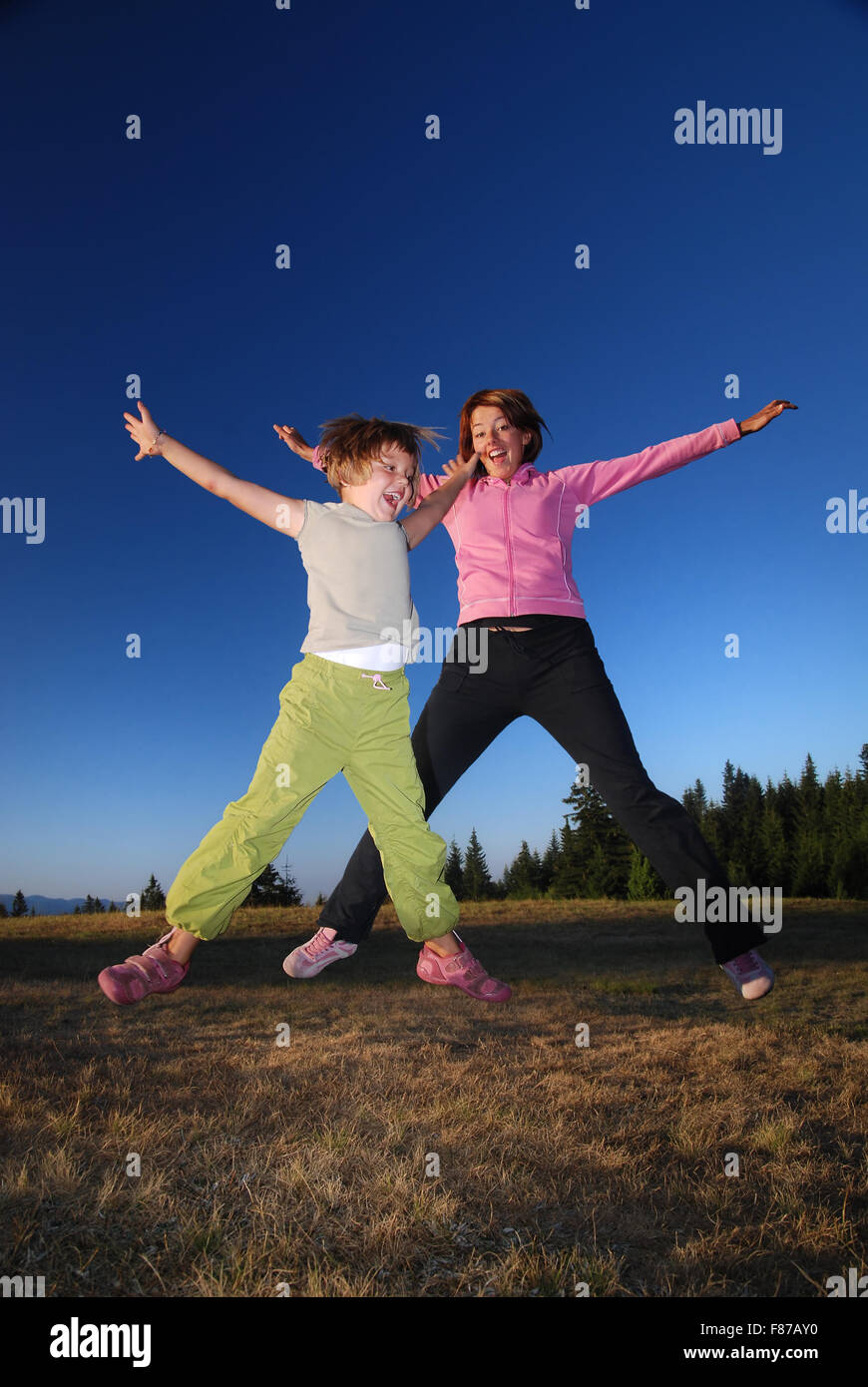 happy girls Jumping in to air Stock Photo - Alamy