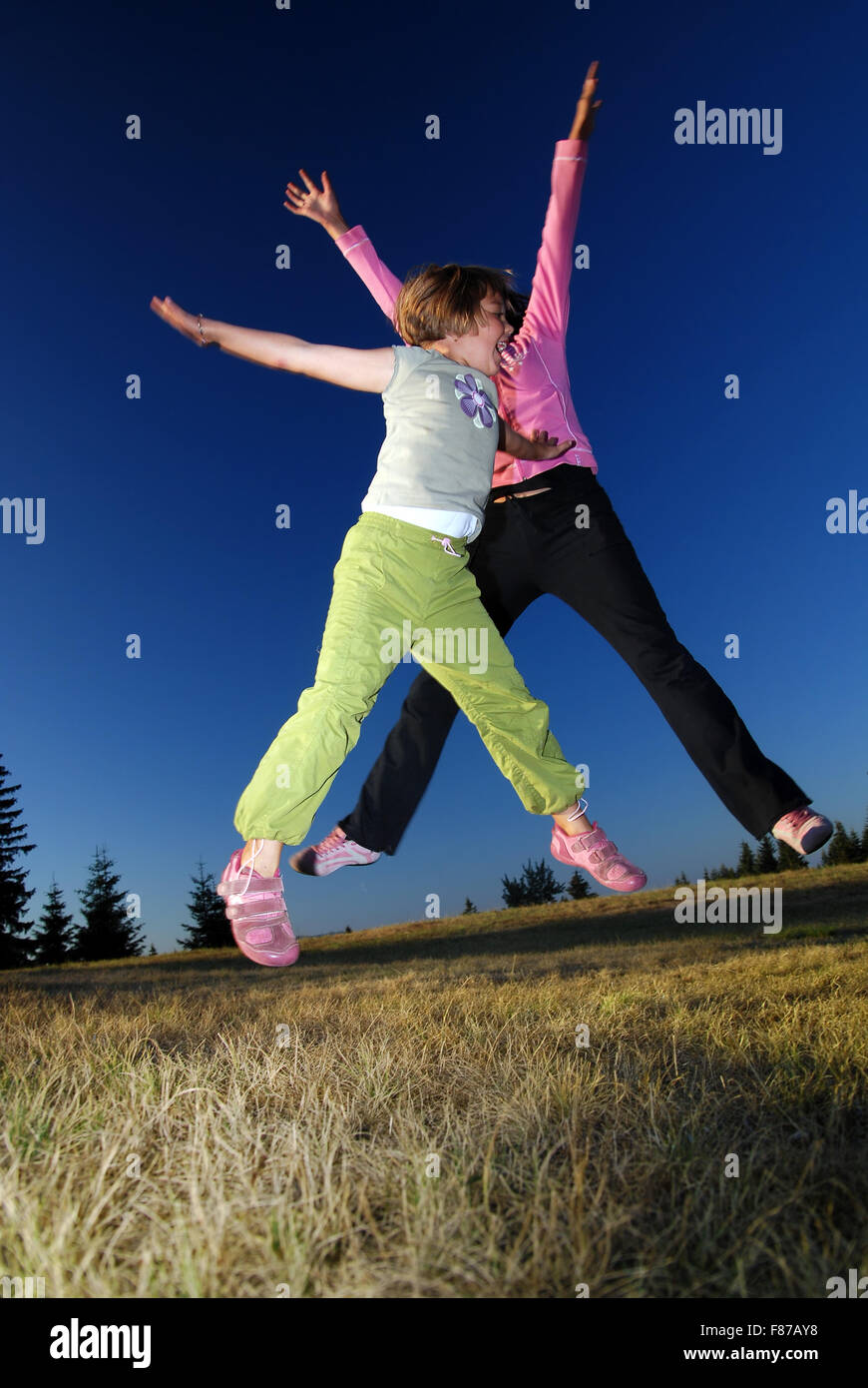 happy girls Jumping in to air Stock Photo - Alamy