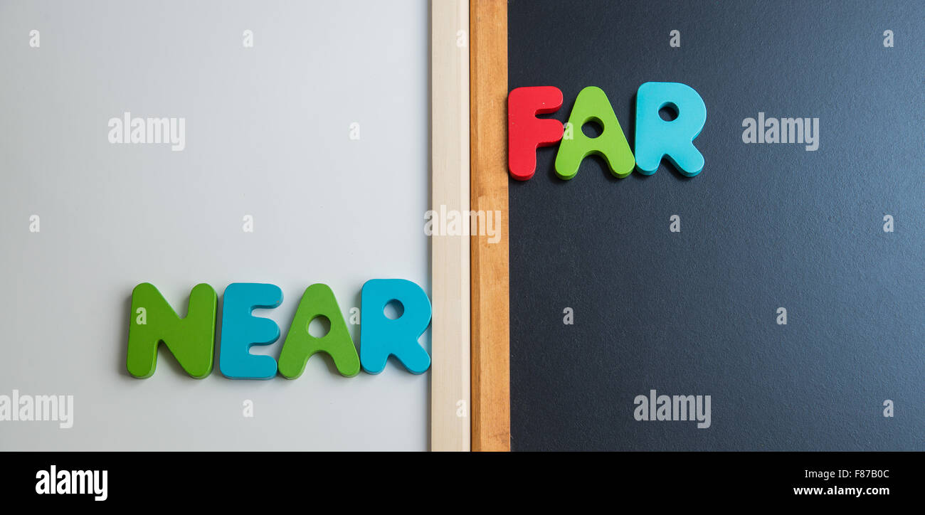 Wooden word NEAR and FAR on black board and white board Stock Photo - Alamy