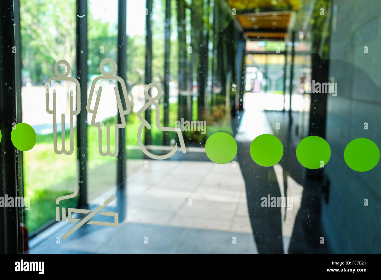 Restroom symbol on glass wall Stock Photo - Alamy