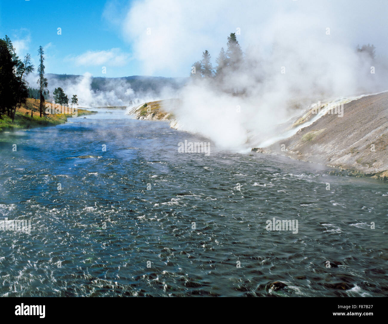 steam rising from hot springs along the firehole river in yellowstone ...