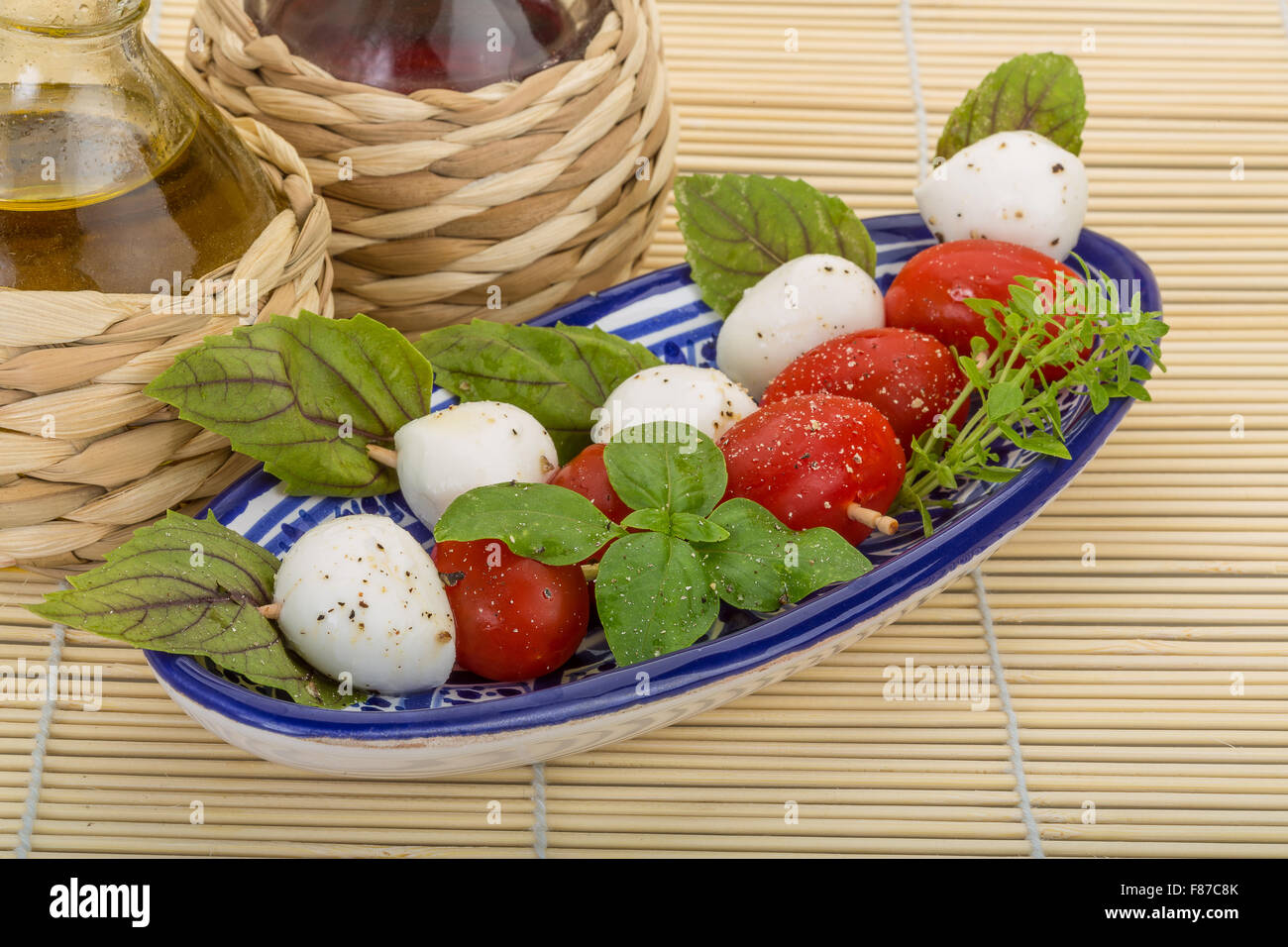 Famous italian caprese salad with fresh basil leaves Stock Photo - Alamy
