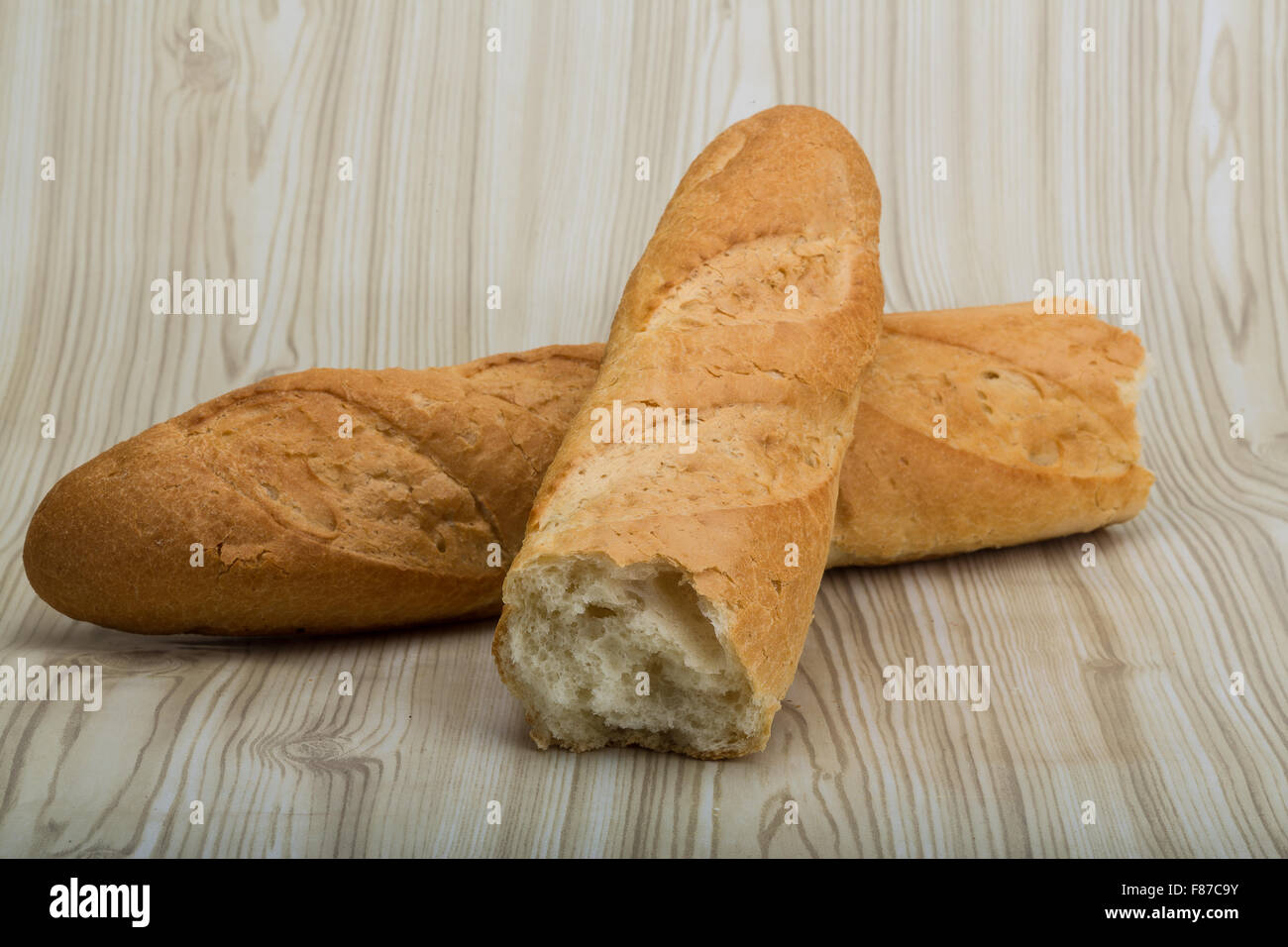 Broken fresh loaf bread on the board Stock Photo - Alamy