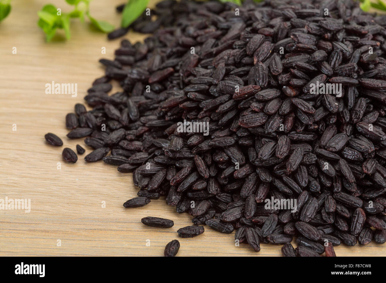 Raw black rice with herbs Stock Photo - Alamy