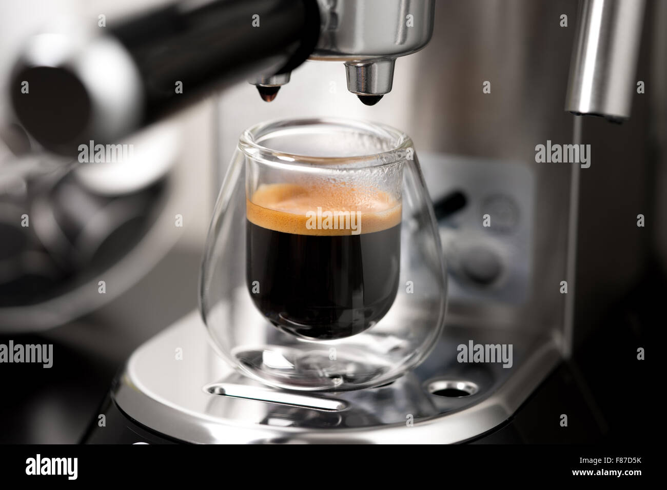Espresso pouring from coffee machine hi-res stock photography and ...