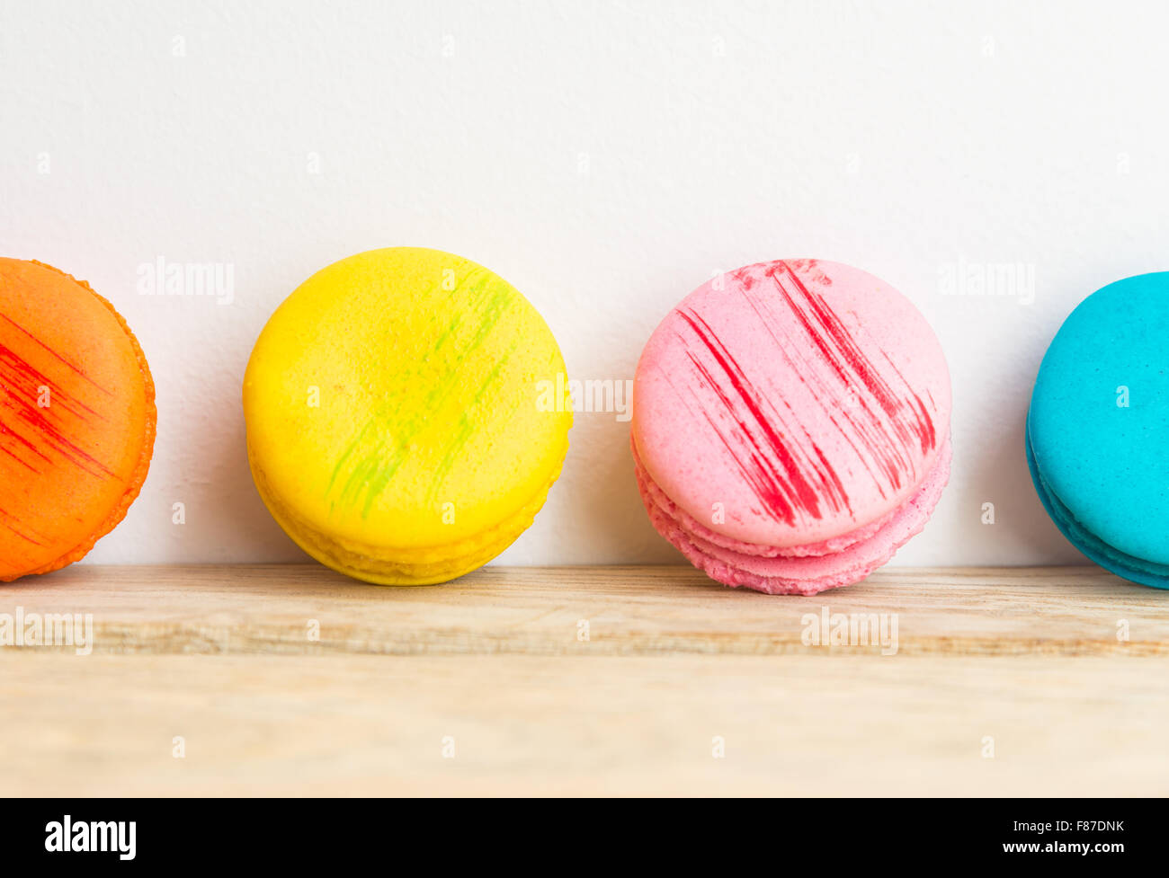 Colorful macaroon with white background on wooden floor Stock Photo - Alamy