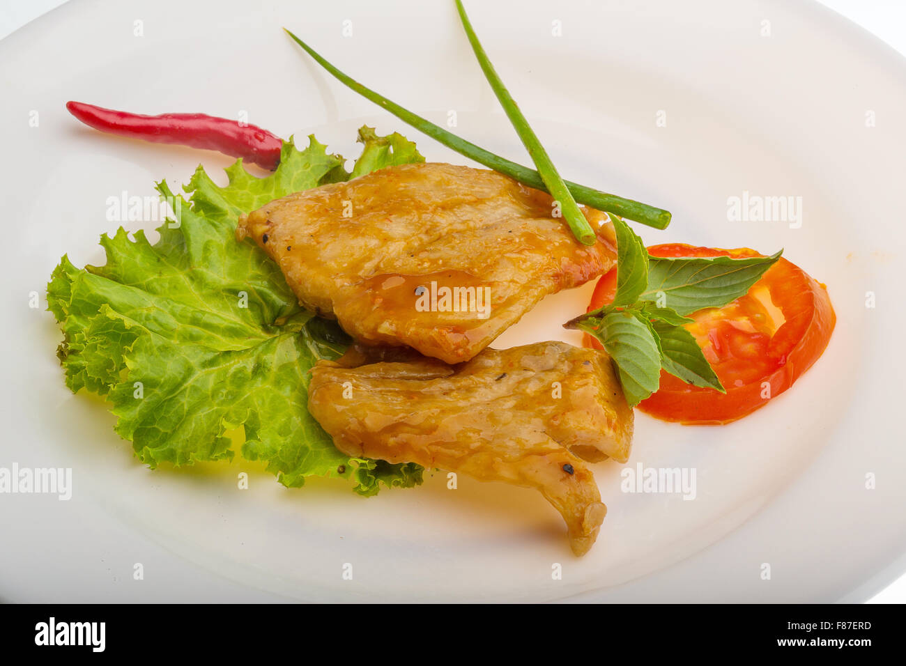 Baracuda steak with sauce and salad Stock Photo - Alamy