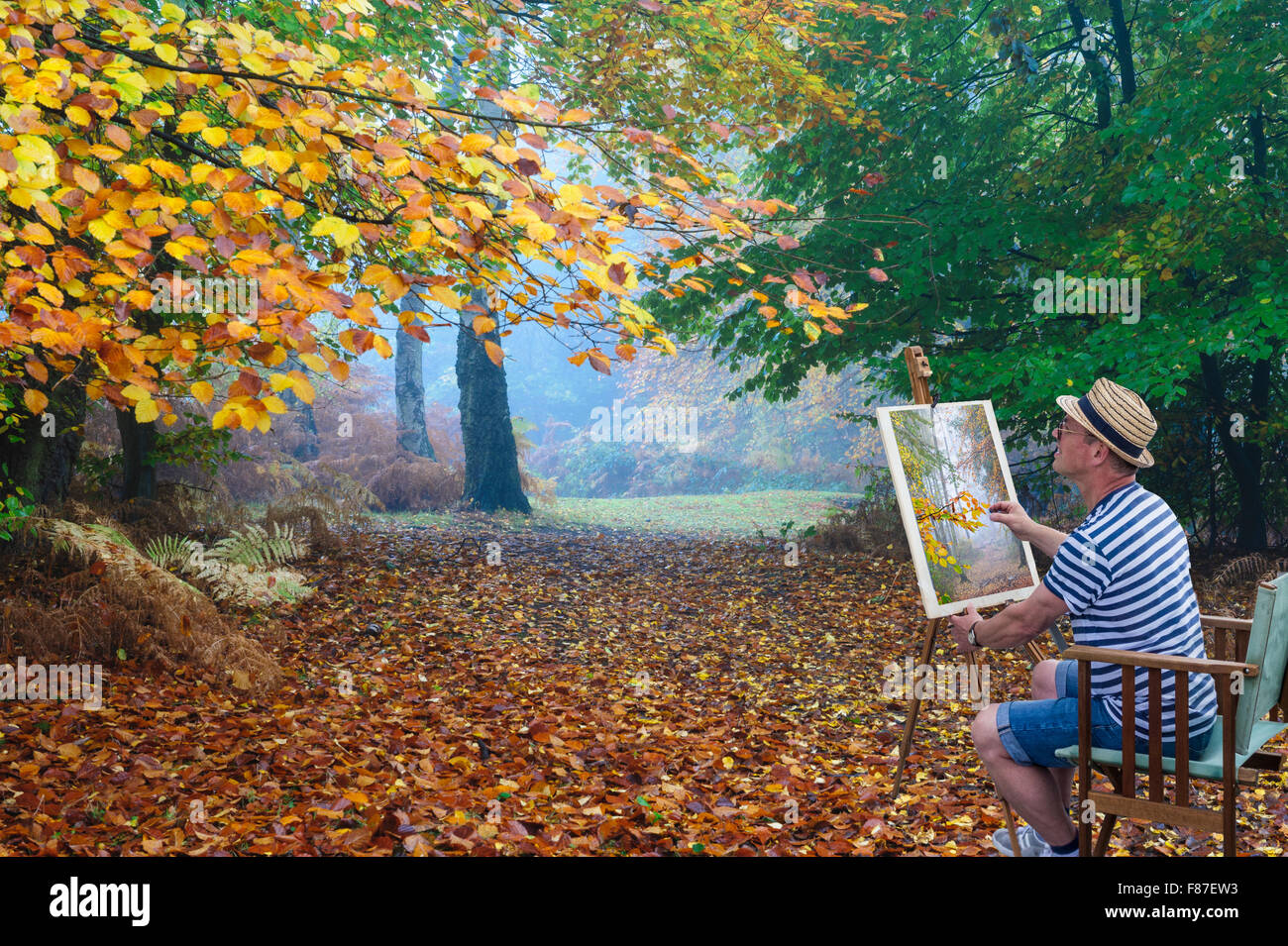 Artist sitting at easel painting Stock Photo - Alamy