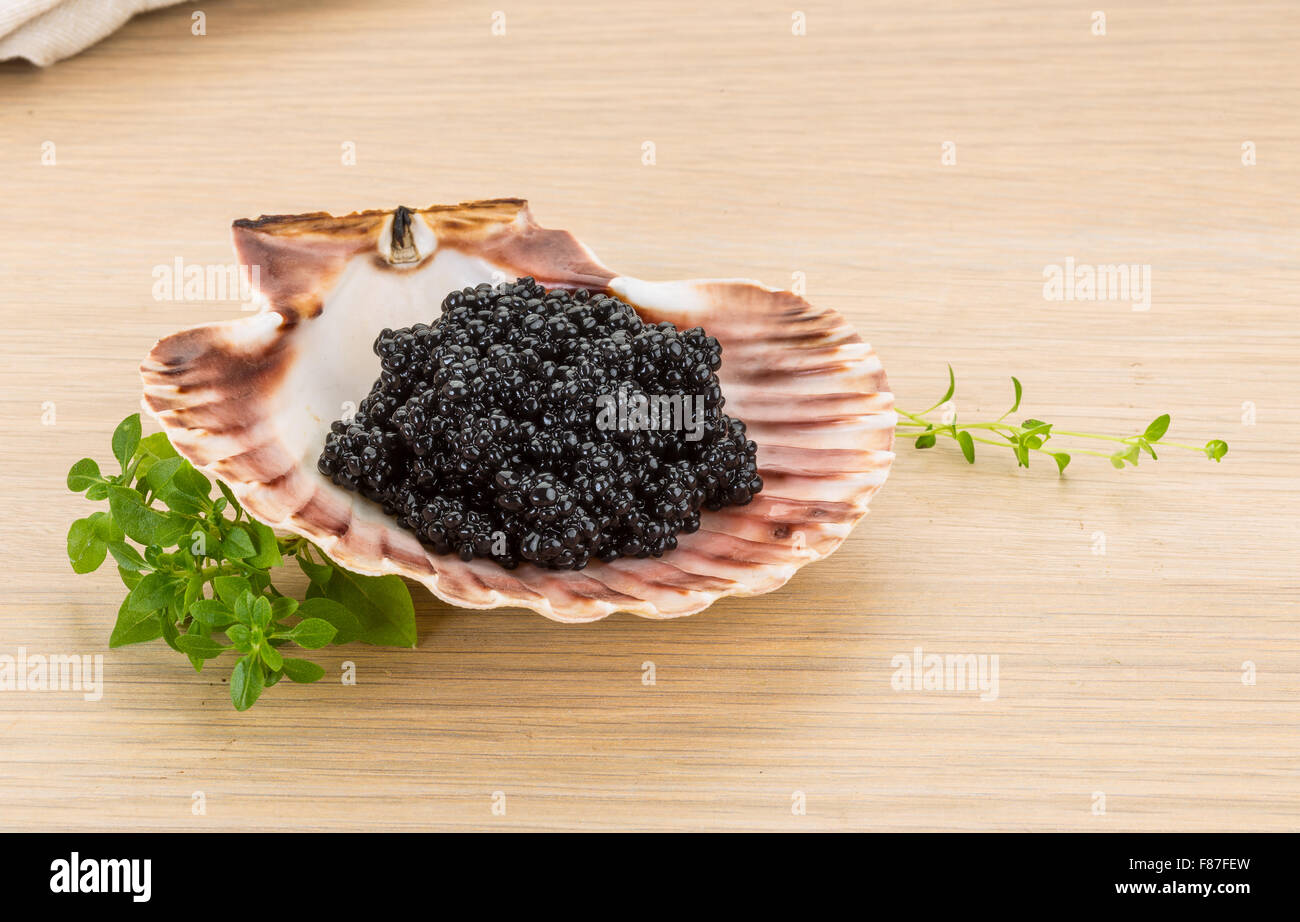 Black caviar in the bowl on board Stock Photo - Alamy