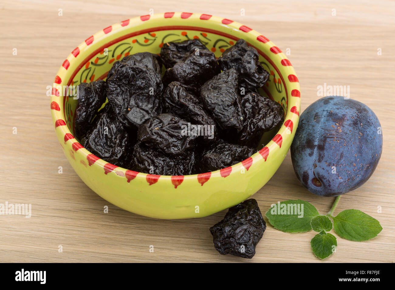 Dried plums in the bowl with fresh prune Stock Photo - Alamy