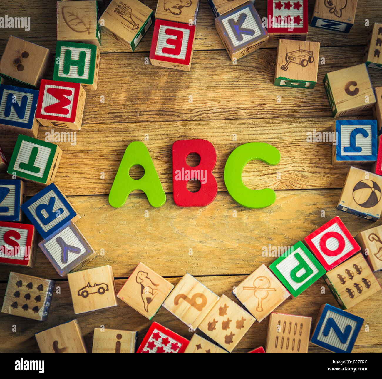 ABC word in wooden block alphabet lay on wooden floor in circle shape ...
