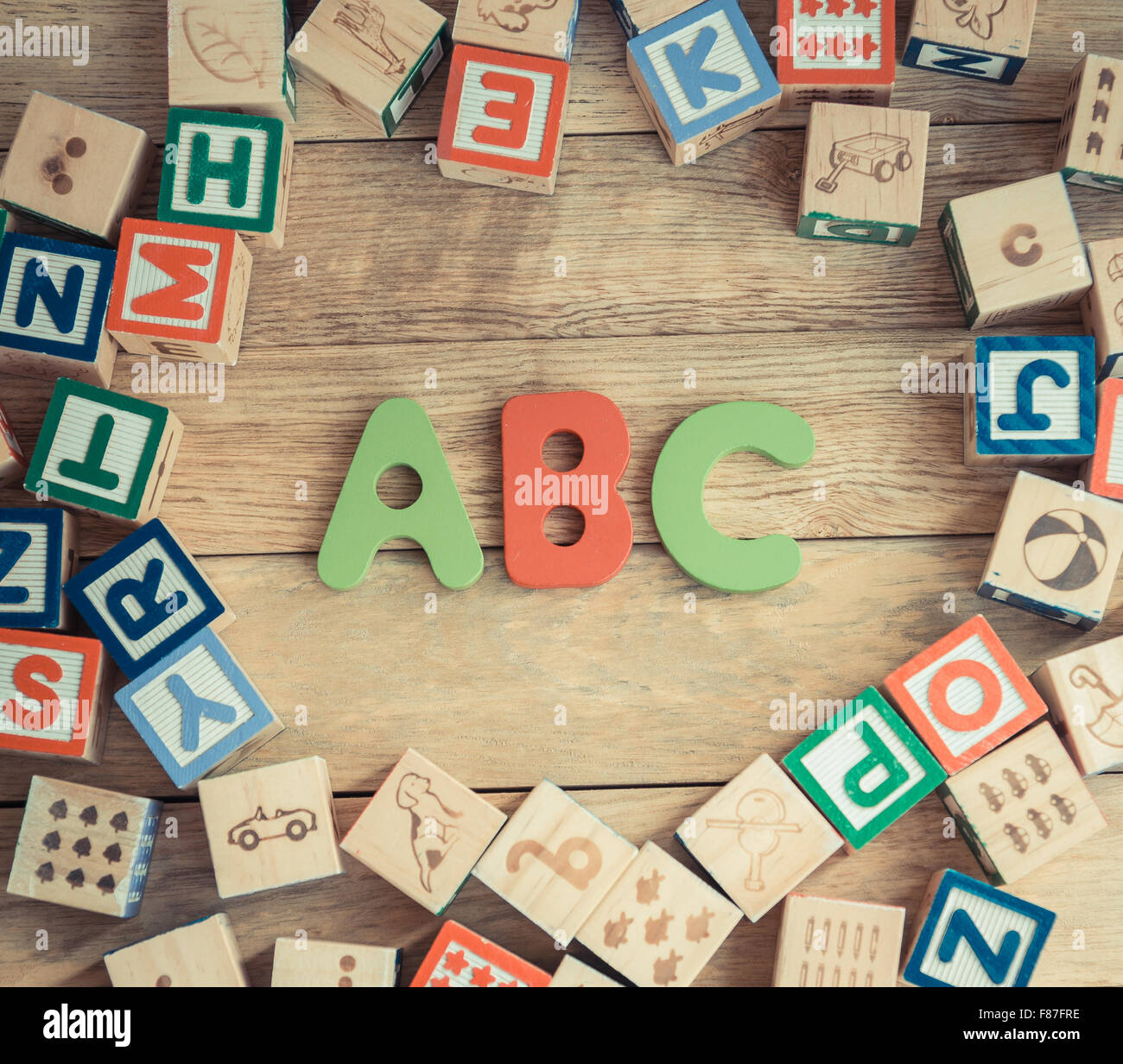 ABC word in wooden block alphabet lay on wooden floor in circle shape ...