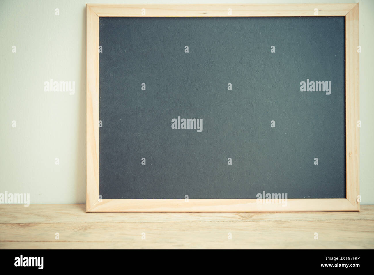 Blank black board on the wall Stock Photo - Alamy