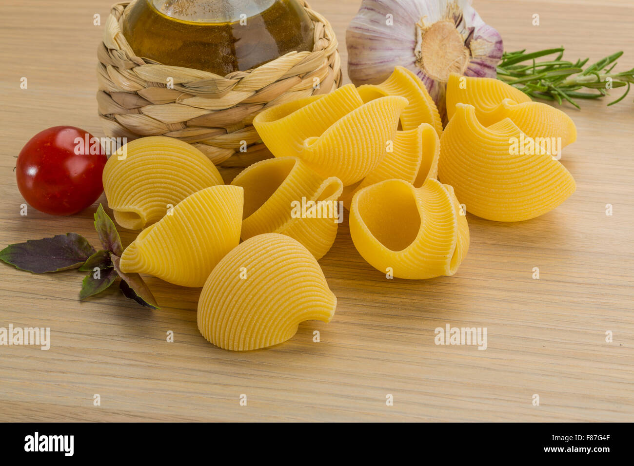 Raw italian pasta with herbs Stock Photo - Alamy