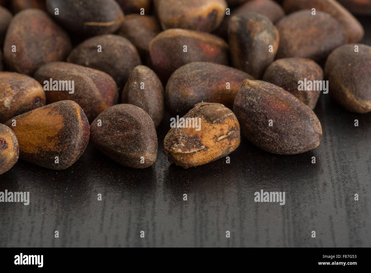 Cedar nuts on the desk Stock Photo - Alamy