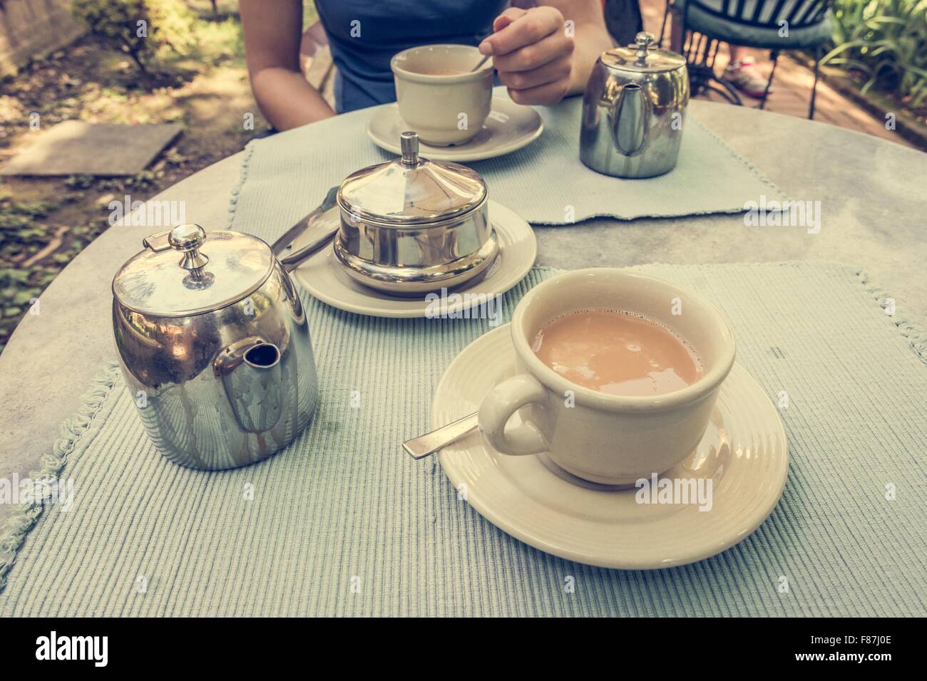 Person enjoying tea Stock Photo - Alamy