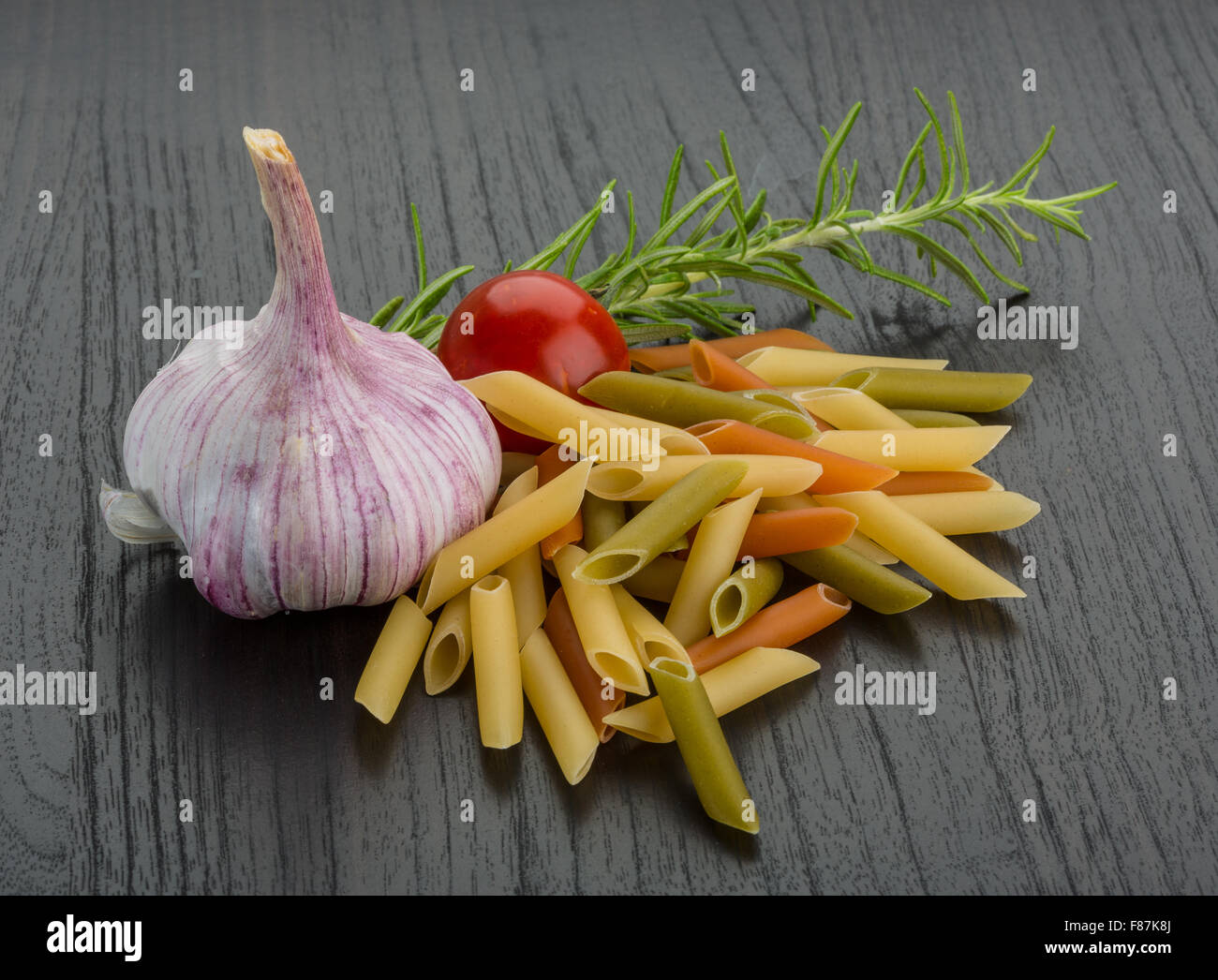 Penne - raw italian pasta with herbs Stock Photo - Alamy