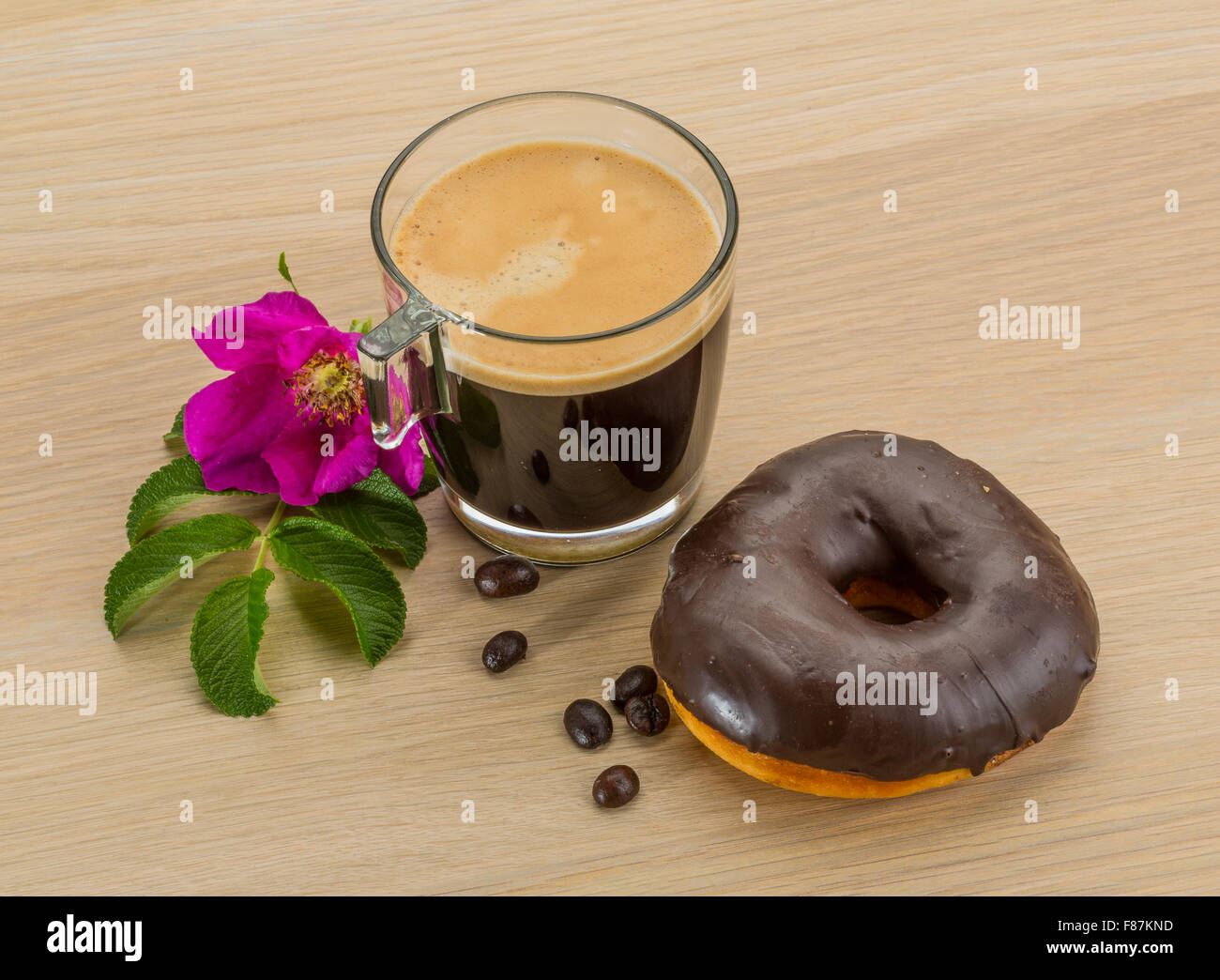 Chocolate donuts with coffee on the desk Stock Photo - Alamy