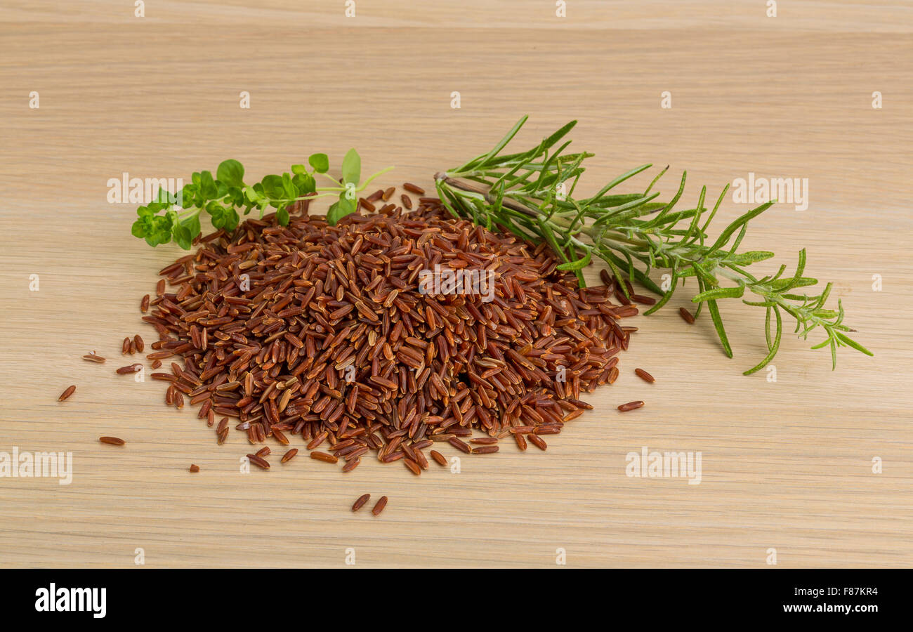 Raw brown rice with herbs Stock Photo - Alamy