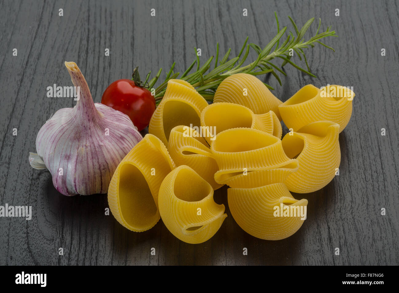 Raw shell pasta with herbs Stock Photo - Alamy