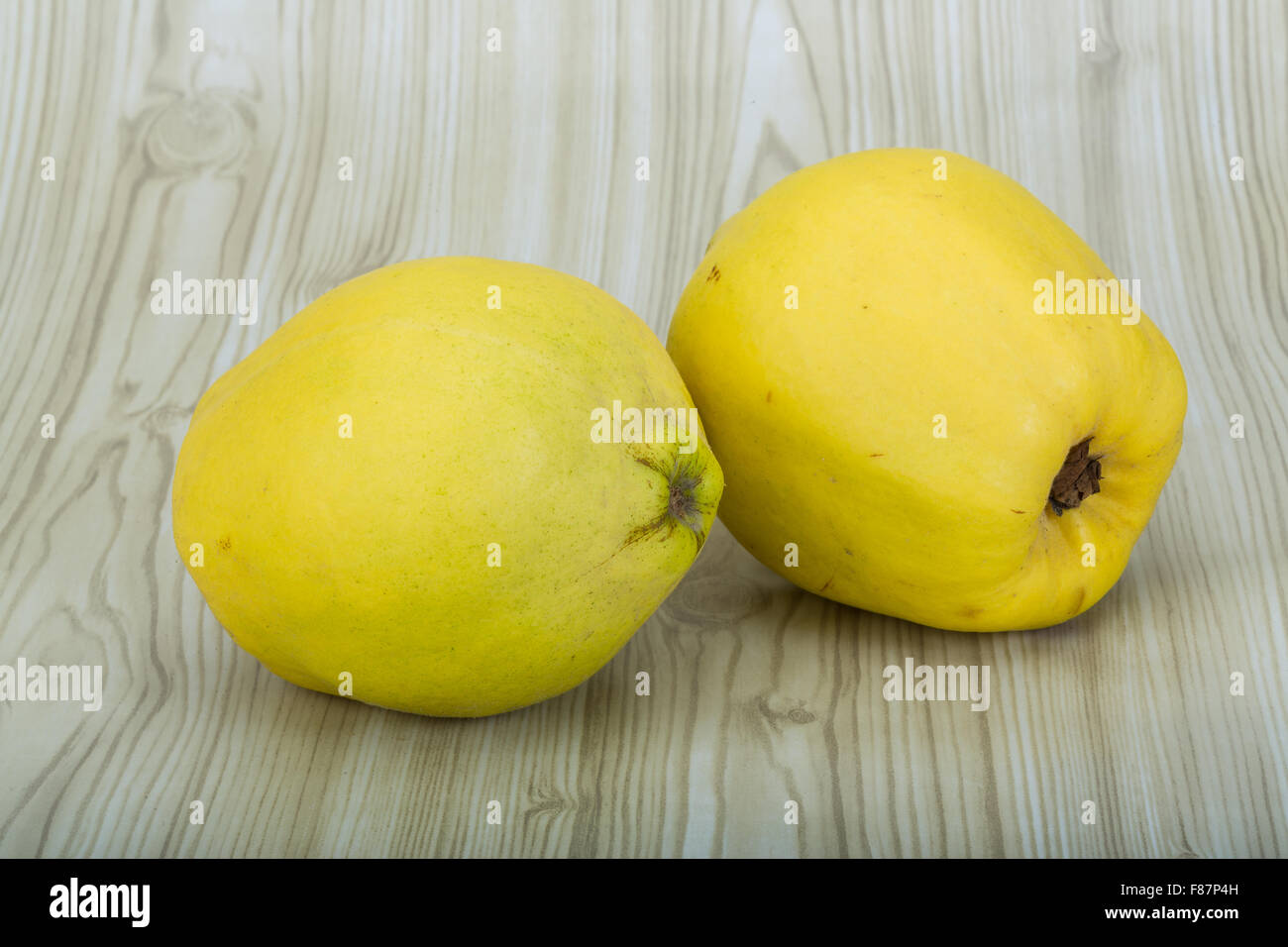 Fresh ripe Quince on the wooden background Stock Photo - Alamy