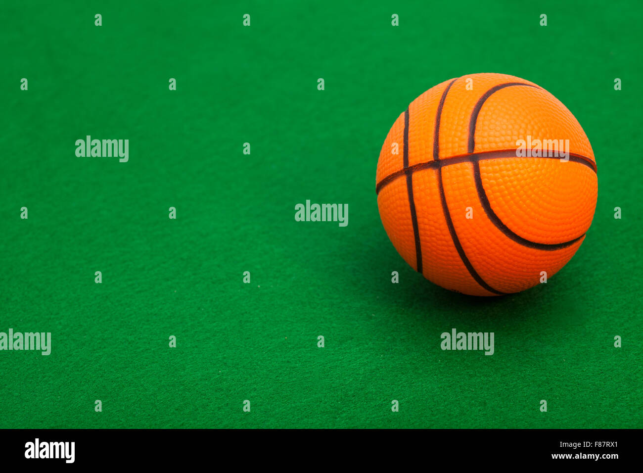 Basketball on green background Stock Photo - Alamy