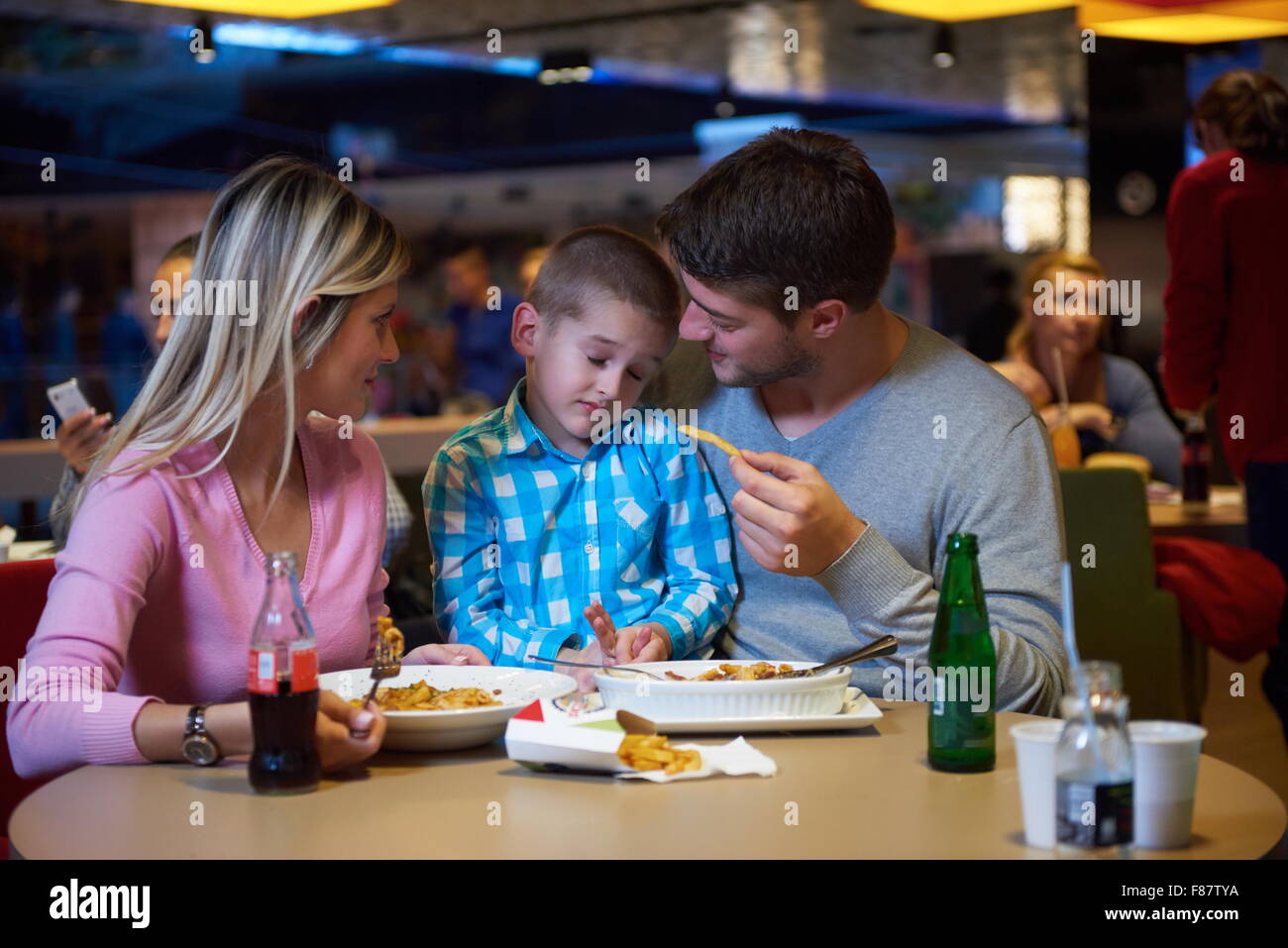 family together have break at lunch in shopping mall Stock Photo - Alamy