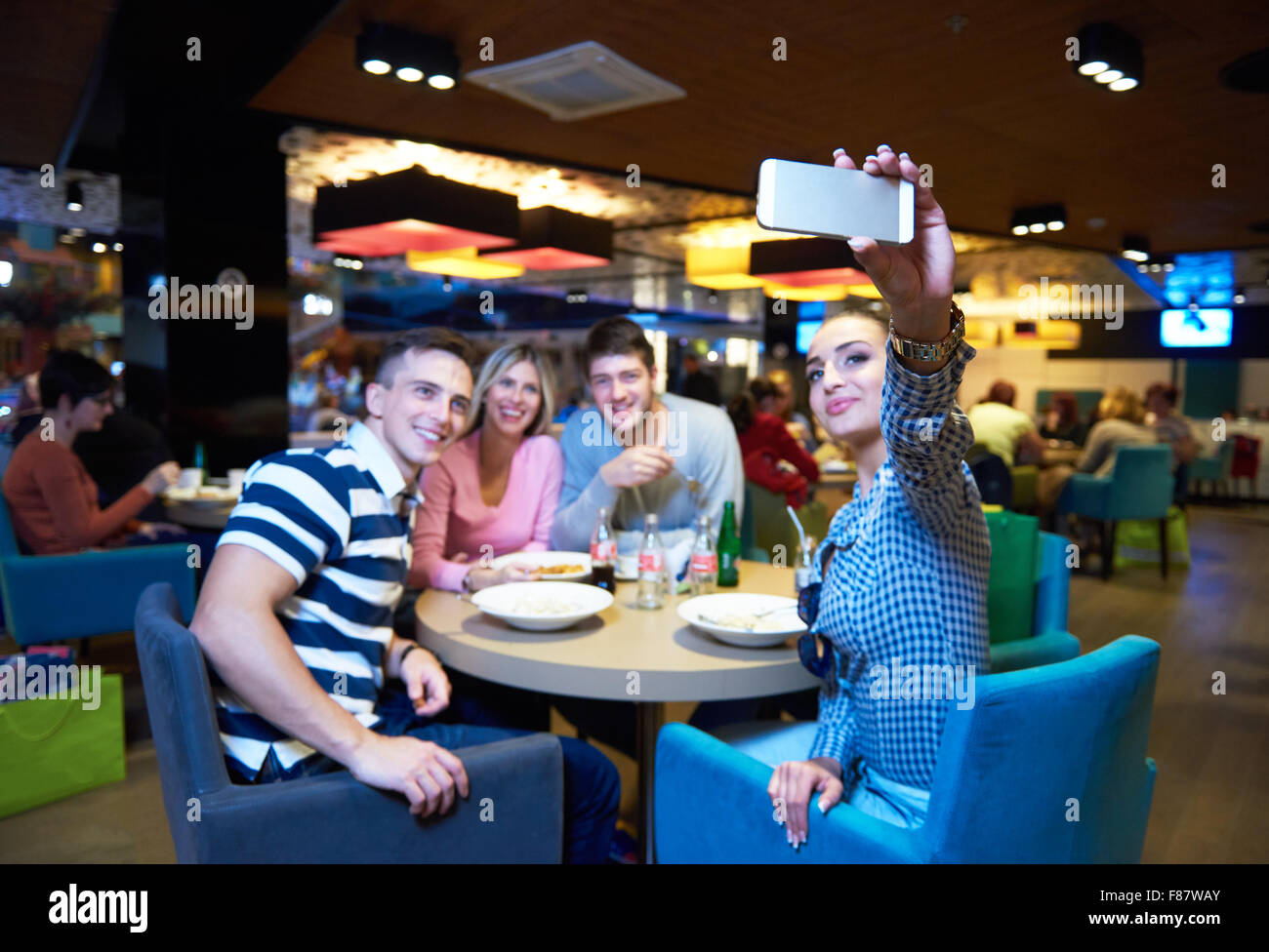 friends have lanch break in shopping mall, eating italian fast food ...