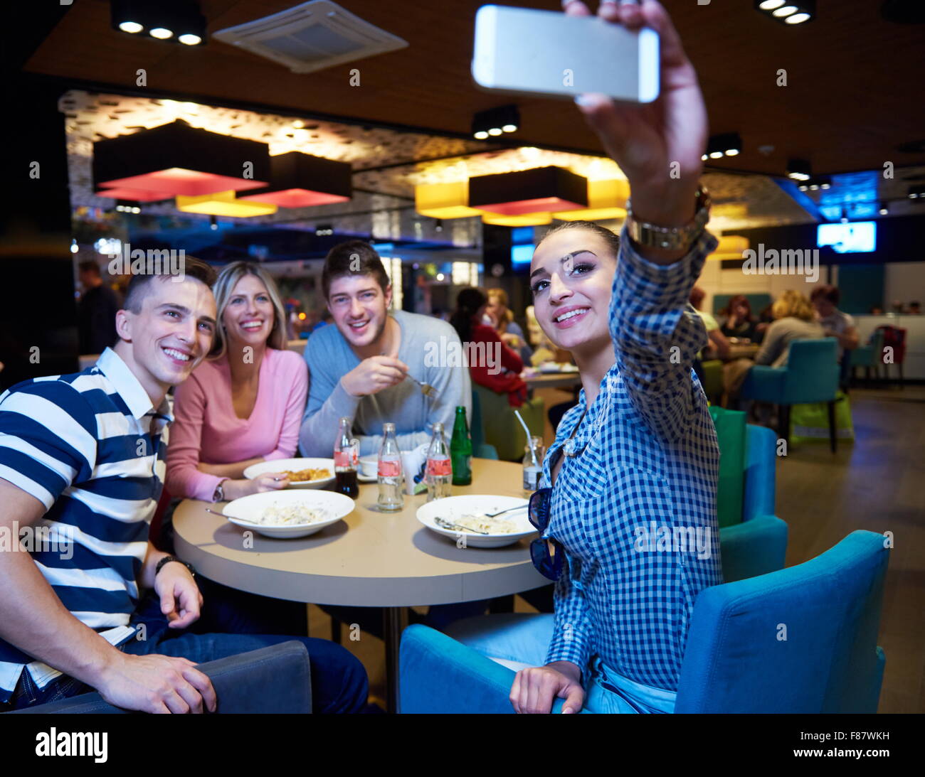 friends have lanch break in shopping mall, eating italian fast food ...