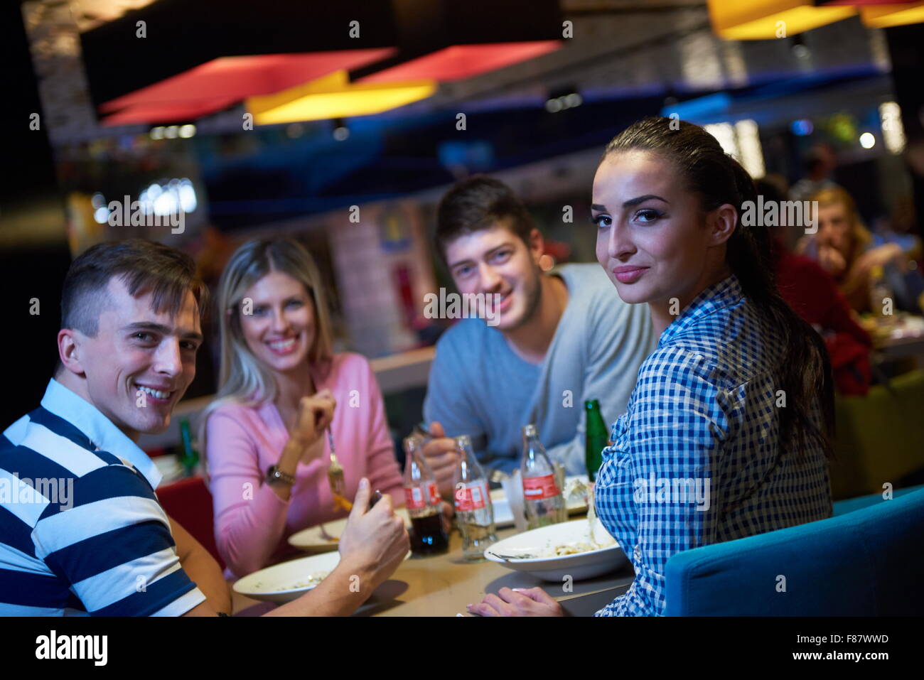 friends have lanch break in shopping mall, eating italian fast food ...
