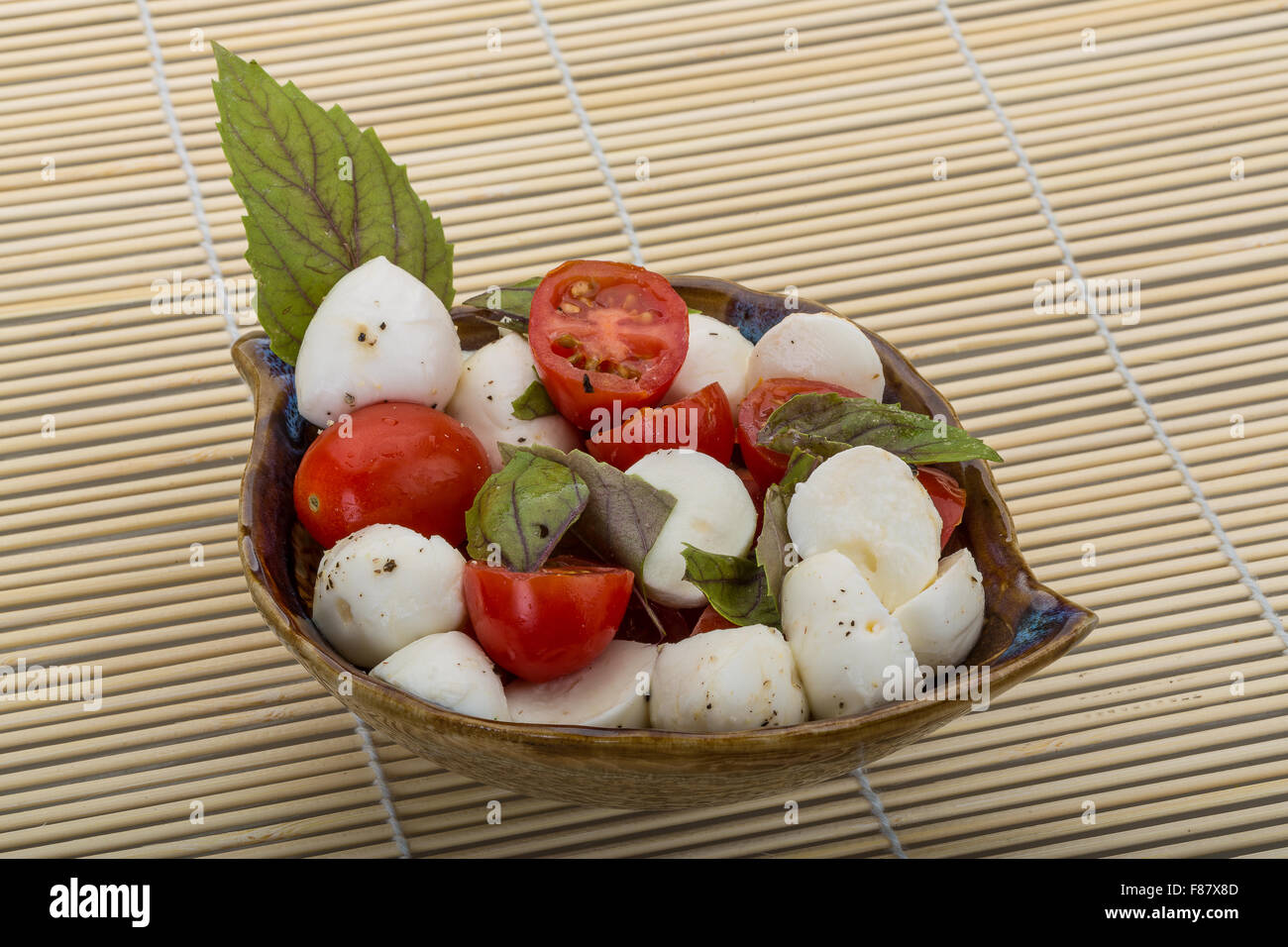 Famous italian caprese salad with fresh basil leaves Stock Photo - Alamy