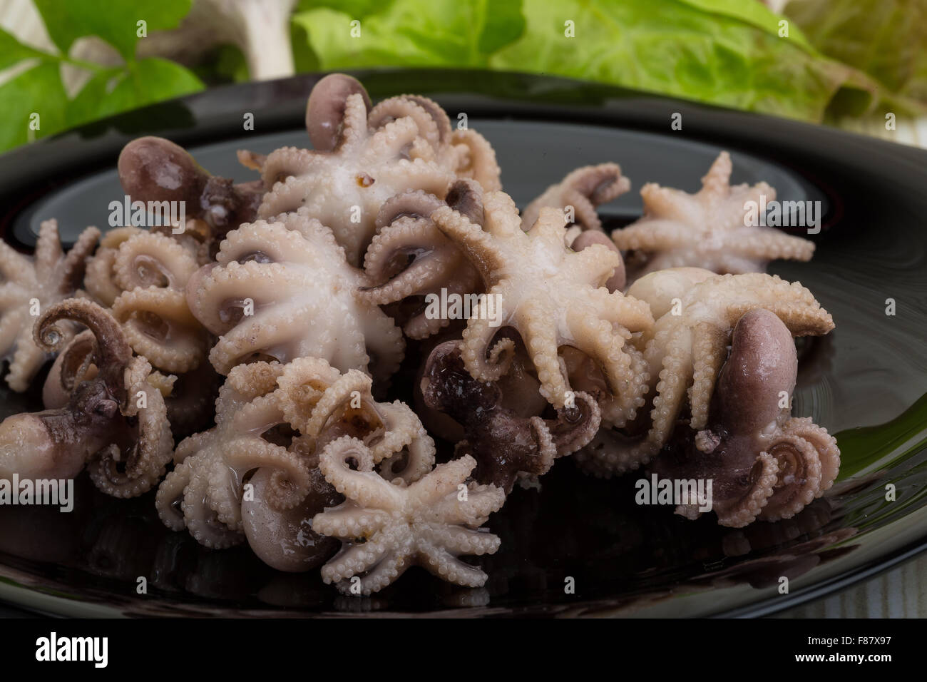 Boiled octopus - mini seafood in the bowl Stock Photo - Alamy