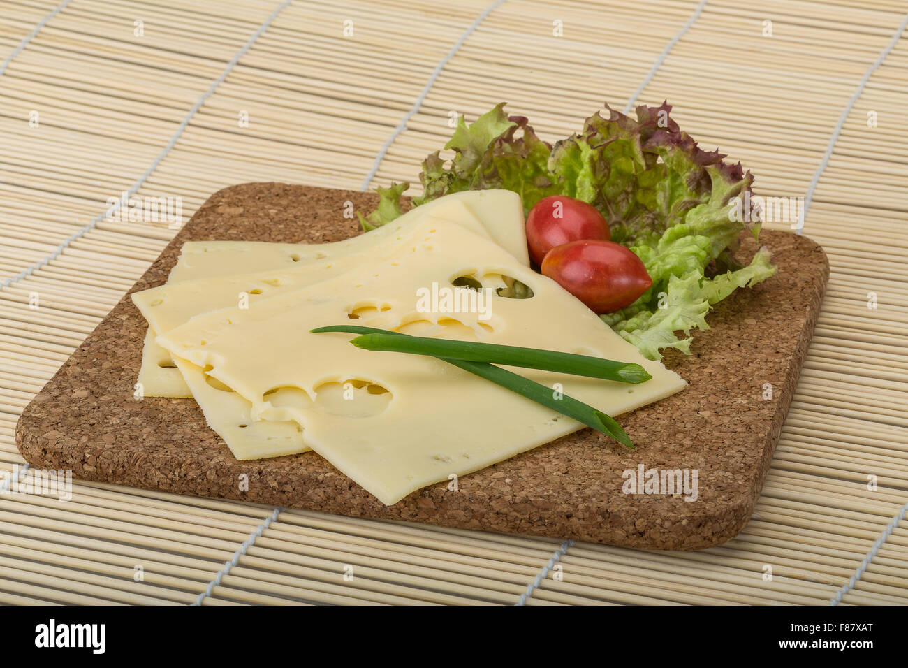 Maasdam cheese slices on the wooden background Stock Photo - Alamy