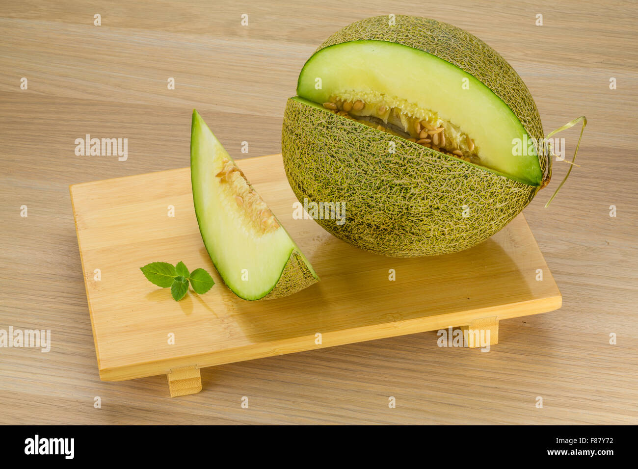 Fresh ripe melon sliced on the desk Stock Photo - Alamy