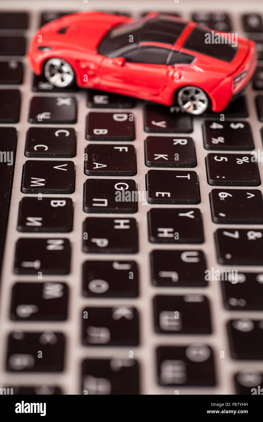 Toy car over laptop keyboard Stock Photo - Alamy