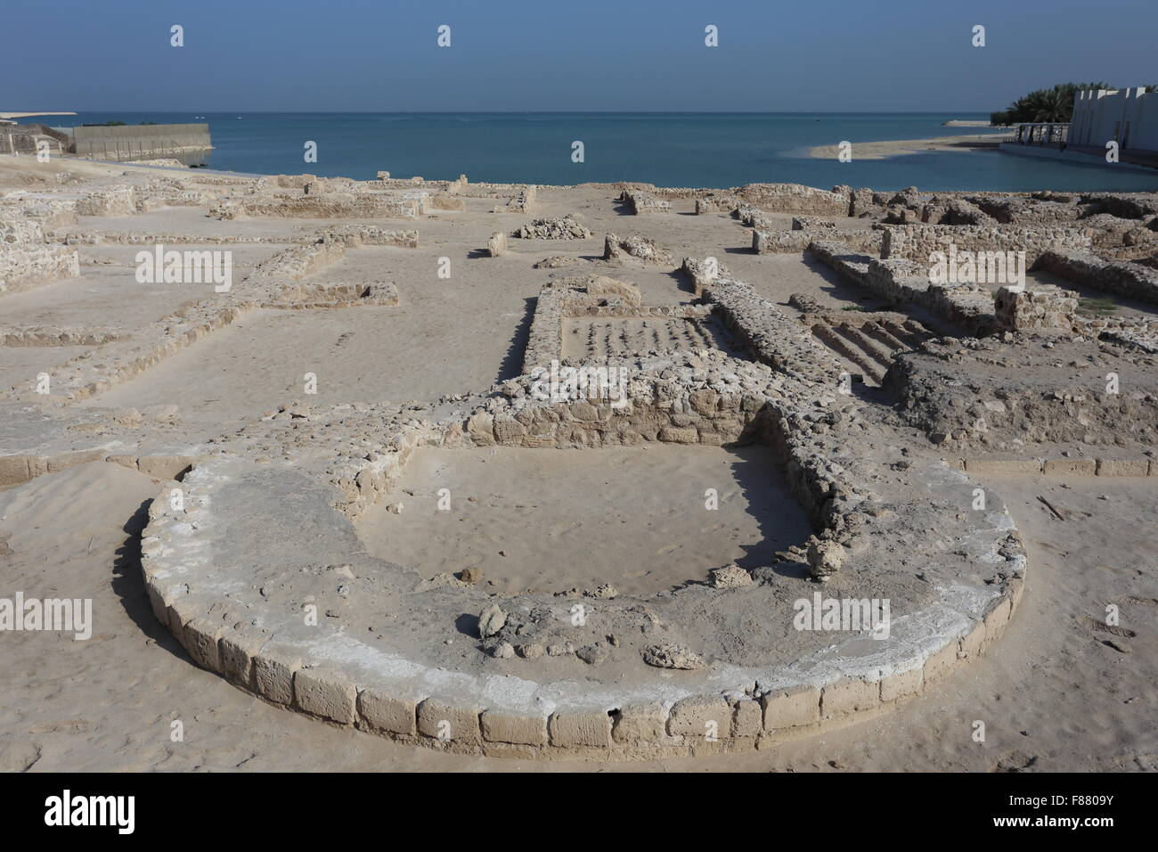 Excavations of Dilmun-era ruins in front, with the Bahrain Fort Museum ...