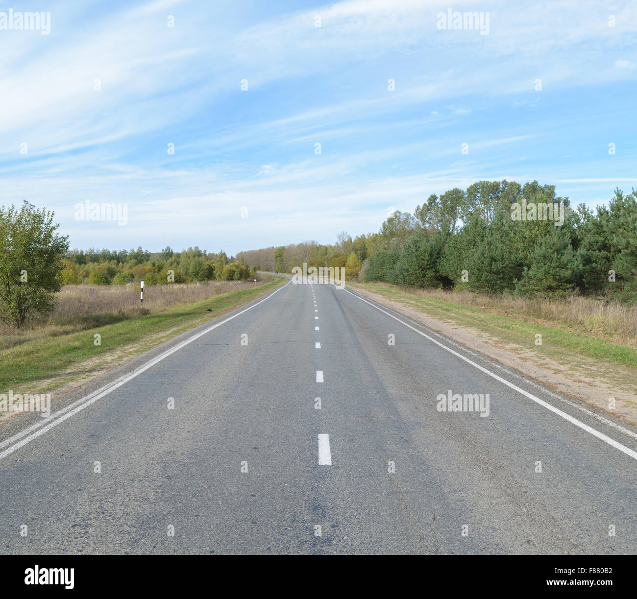Receding into the distance suburban asphalt highway with white ...