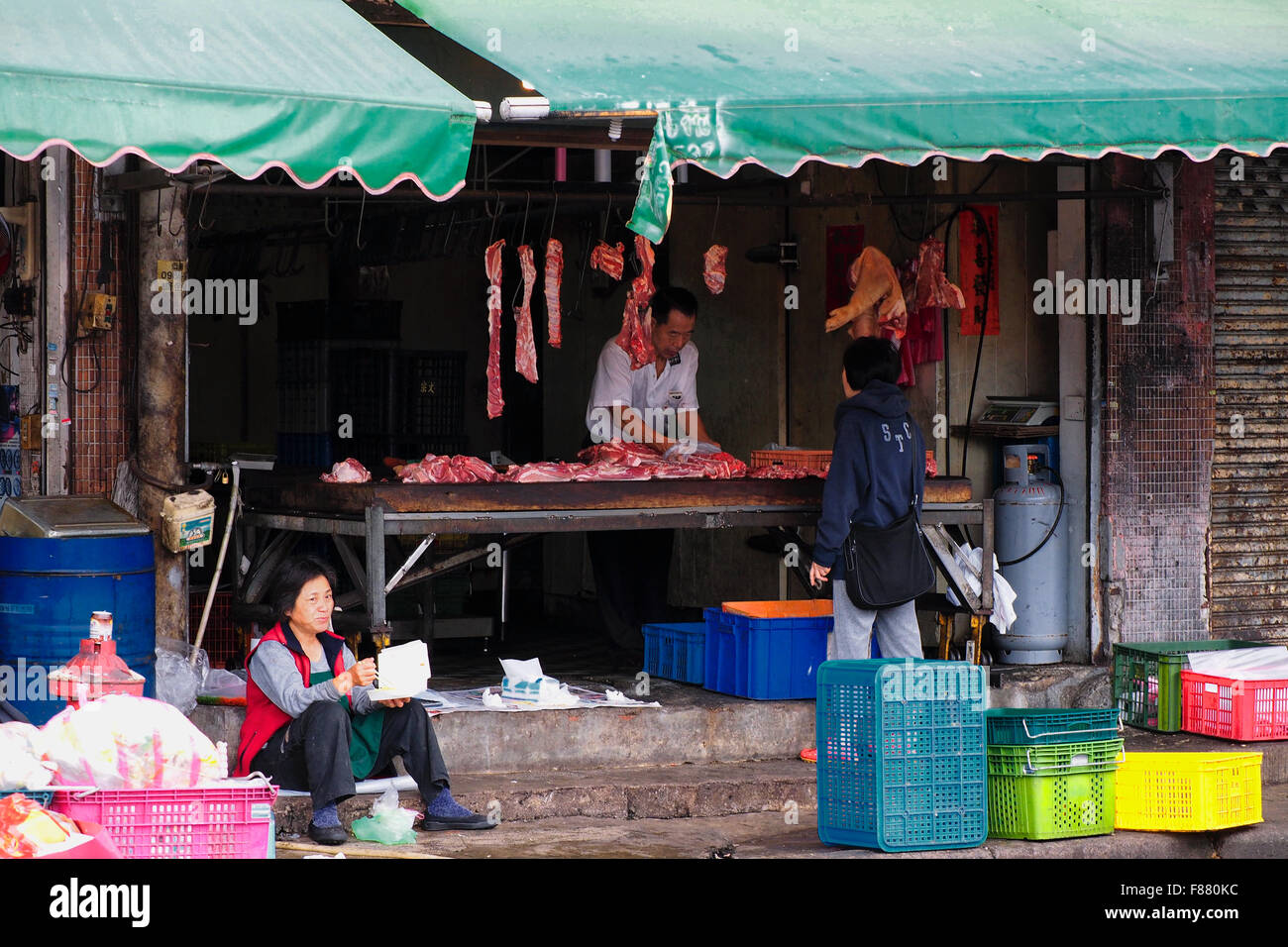 Taiwanese Chinese male butcher selling fresh meat at a traditional ...