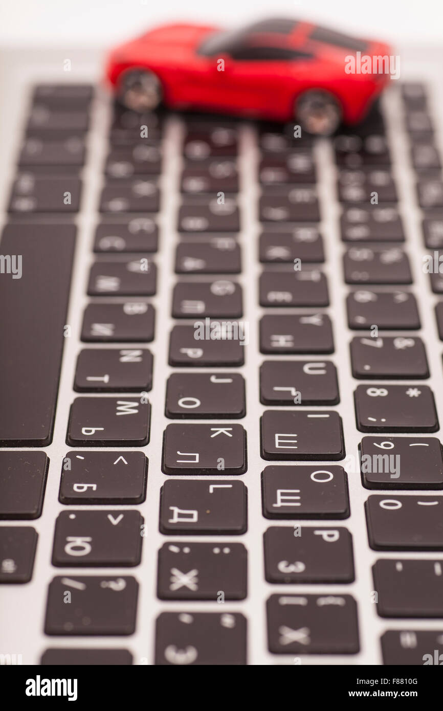 Toy car over laptop keyboard Stock Photo - Alamy