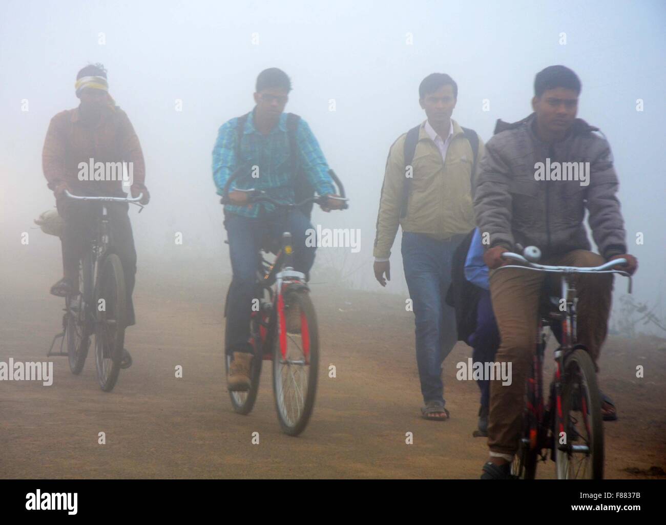 Allahabad, India. 07th Dec, 2015. Youth paddle cycle as the wrapped in ...