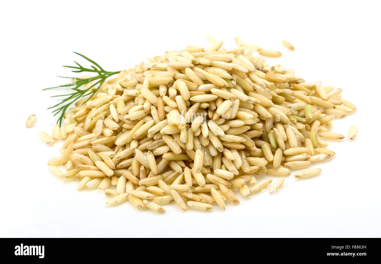 Yellow wild rice heap isolated Stock Photo - Alamy