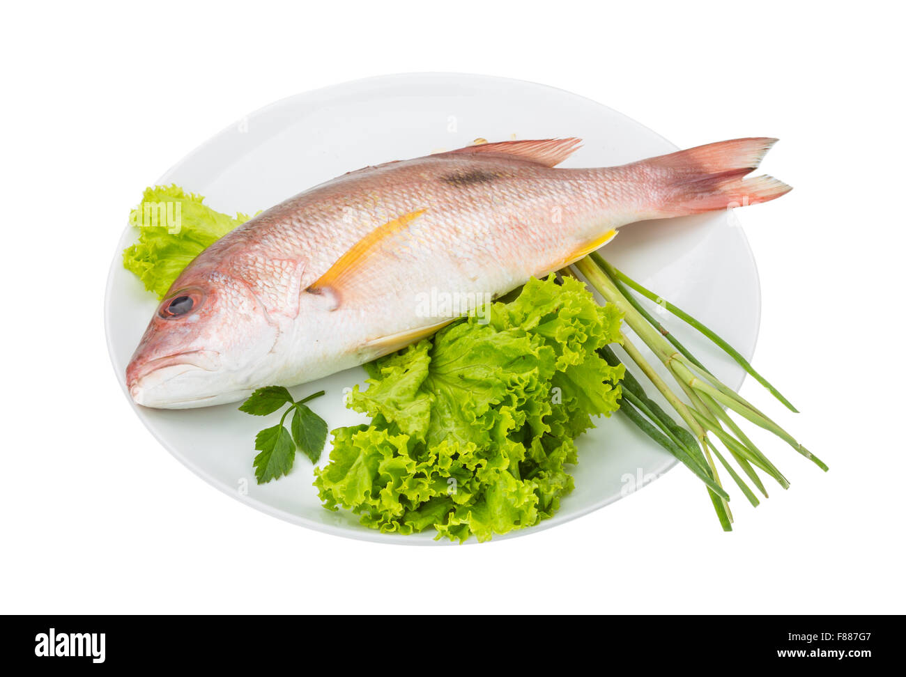 Raw red snapper with salad leaves Stock Photo - Alamy